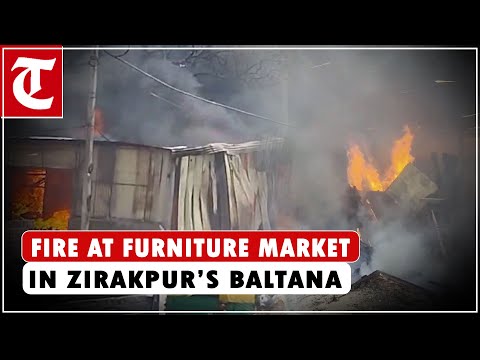 Firefighters try to douse flames after fire breaks out at furniture ...