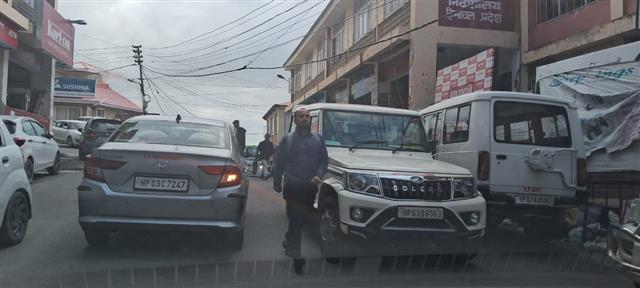 Govt vehicles parked on road obstruct traffic - The Tribune